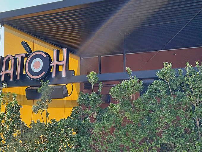 The sunny yellow exterior of Hatch announces its presence like a breakfast beacon, complete with that iconic egg-in-the-O logo.