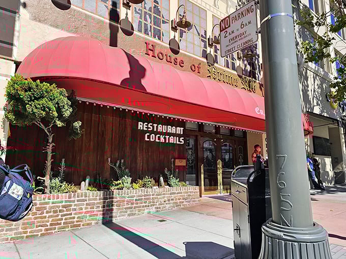 The iconic red awning beckons meat lovers like a carnivorous lighthouse on Van Ness Avenue, promising beef-filled dreams since 1949.