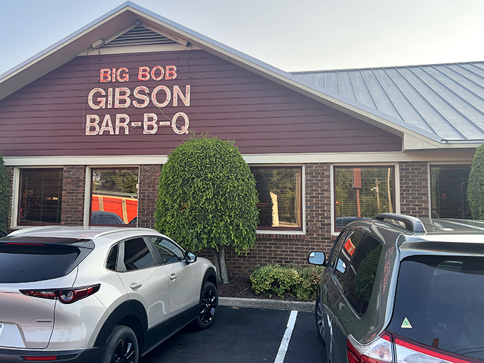 The neon sign glows like a barbecue beacon, promising smoky salvation to hungry travelers. Big Bob Gibson's exterior says it all: serious barbecue happens here.