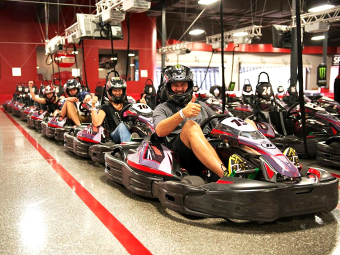 The entrance to Octane Raceway stands like a modern-day coliseum for speed demons, palm trees swaying as if applauding your imminent victory lap.