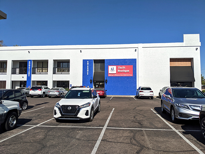 The bright blue exterior stands out like a sapphire in the desert, promising air-conditioned treasure hunting within. No mirage here, folks!