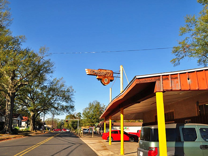 The bright yellow sign with its cartoon potato mascot stands as a cheerful time capsule from 1948, welcoming hungry visitors to El Dorado's sweetest tradition.