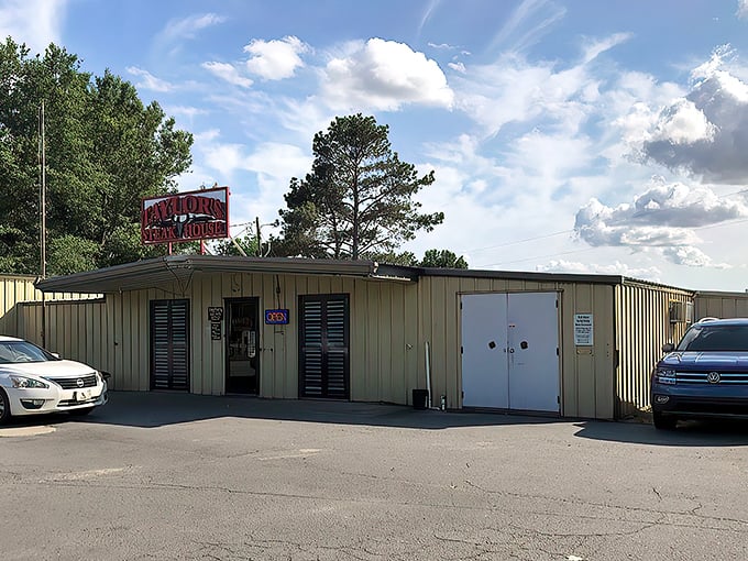 The unassuming exterior of Taylor's Steakhouse stands like a carnivore's lighthouse in Dumas, its iconic red sign promising meaty treasures within.