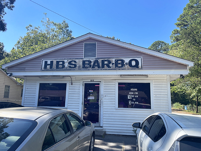 The unassuming white clapboard exterior of H.B.'s Bar-B-Q stands like a beacon to barbecue pilgrims. No fancy frills, just smoke signals of deliciousness within.