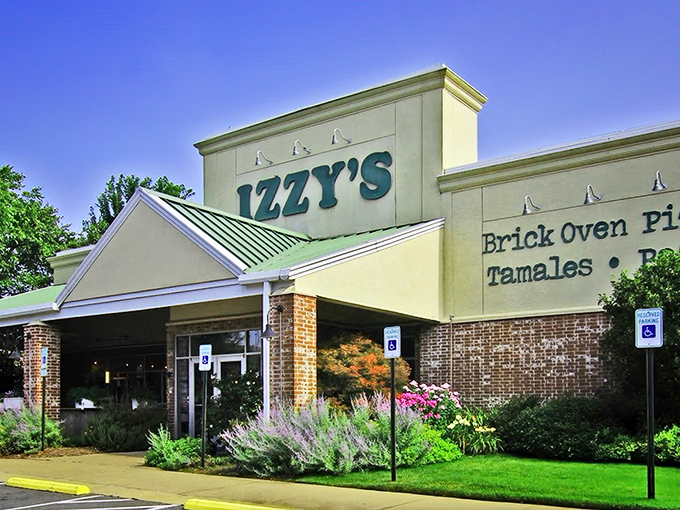 Izzy's welcomes hungry travelers with its distinctive green-trimmed roof and promise of brick oven delights&mdash;like finding a culinary oasis in Little Rock.