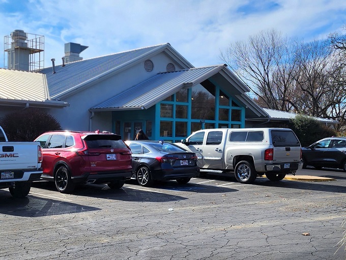 The turquoise-framed entrance of The Catfish Hole stands like a beacon of Southern comfort food, promising delicious treasures within its unassuming exterior.