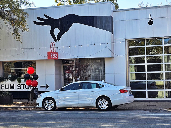 The striking exterior features a giant hand clutching a red purse&mdash;like King Kong if he'd had better fashion sense.