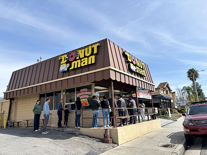The humble roadside stand with its iconic yellow sign sits against the San Gabriel Mountains like a sweet oasis on Route 66.