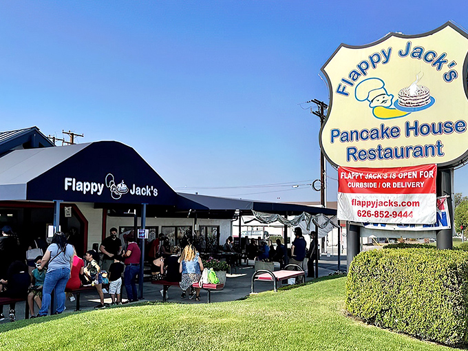 The blue-roofed sanctuary of breakfast dreams awaits on Route 66, where hungry pilgrims find solace in sizzling skillets and coffee refills.