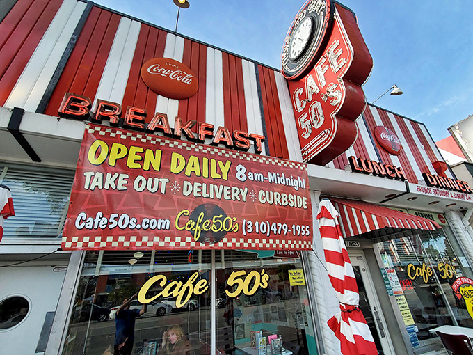 The neon glow of Cafe 50's beckons like a time machine disguised as a diner. Route 66 nostalgia never tasted so good.