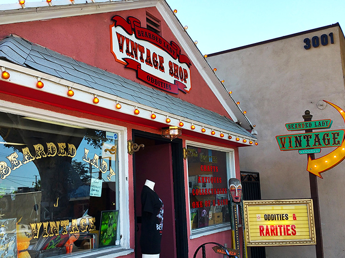 The vintage shop exterior glows with retro charm, beckoning curious souls with its crimson fa&ccedil;ade and twinkling carnival lights. Adventure awaits!