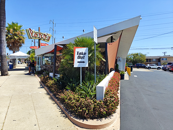 That iconic angular roof isn't just showing off&mdash;it's practically waving you in from the highway, promising comfort food beneath its Googie glory.