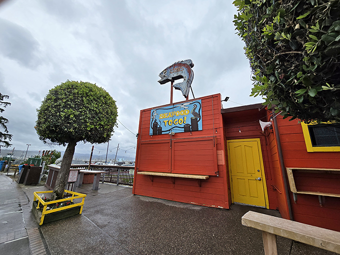 The iconic orange-red exterior of Barbara's Fishtrap stands like a delicious mirage against the Half Moon Bay coastline, complete with a whimsical fish sign that's practically winking at hungry passersby.