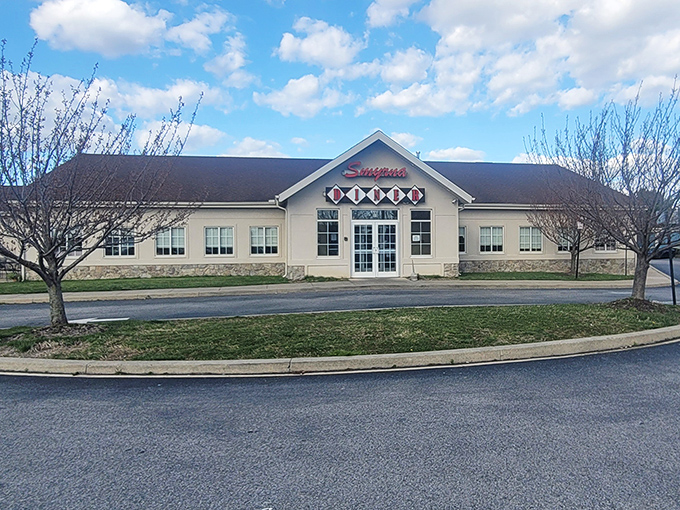The iconic Smyrna Diner welcomes hungry travelers with its distinctive diamond-patterned sign and cozy stone facade. Delaware comfort food headquarters since the 1950s.