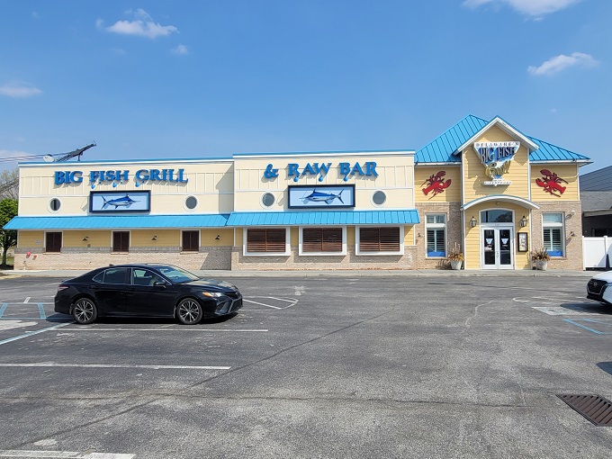 The cheerful yellow exterior of Big Fish Grill beckons like a maritime lighthouse for hungry souls. Blue accents and nautical touches promise seafood salvation ahead.