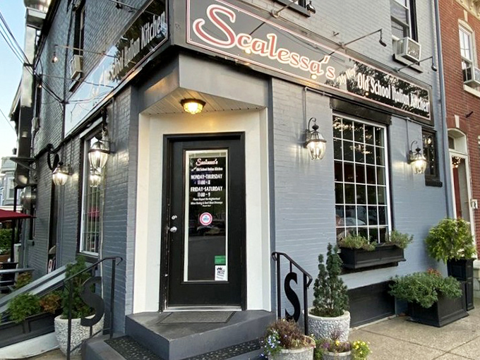 The blue-bricked charm of Scalessa's exterior, with its vibrant flower boxes and vintage lighting, promises an authentic Italian experience hiding in plain sight.