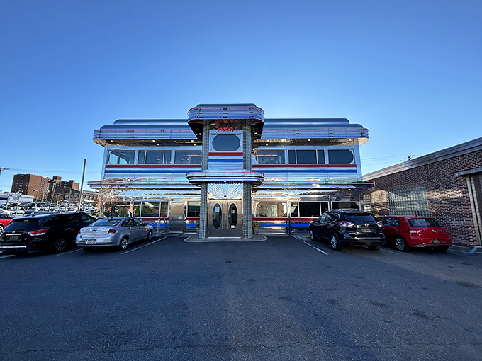 The gleaming chrome exterior of Goobers Diner stands like a time machine to the 1950s, complete with those iconic red and blue stripes that practically scream "great breakfast inside!"