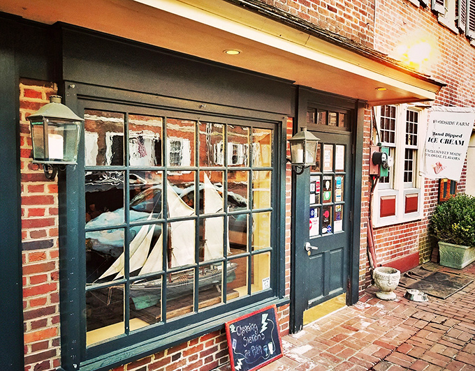 The British Union Jack flutters above Jessop's Tavern, a colonial time machine disguised as a brick building on a cobblestone New Castle street.