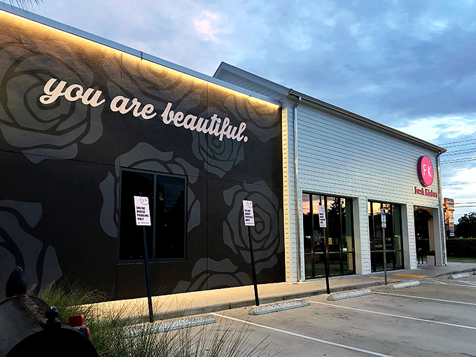 Fresh Kitchen's crisp white exterior with that eye-catching magenta logo stands out like a culinary beacon among Lakeland's palm trees.