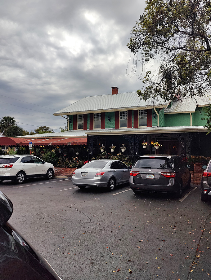 The green building with cherry-red awnings stands like a time capsule of comfort food dreams. Florida's culinary equivalent of finding a $20 bill in your winter coat.