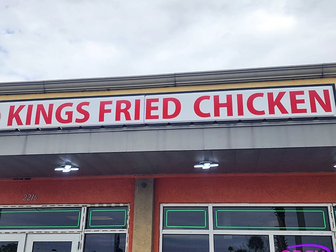 The bright yellow facade with bold red lettering stands as a no-nonsense declaration: this place means serious business when it comes to fried chicken.