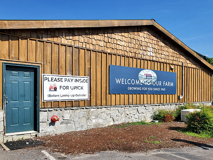 Welcome to paradise! The rustic wooden exterior of Mercier Orchards invites visitors with its "Welcome to Our Farm" sign and promise of U-pick adventures.