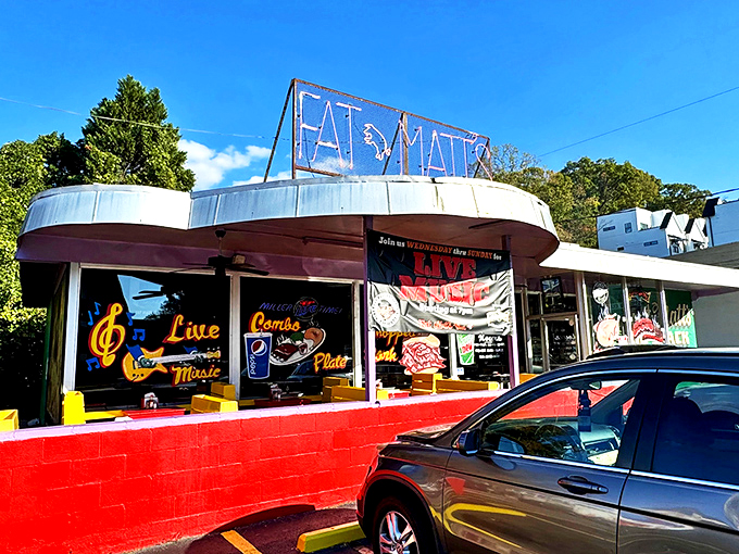 The iconic purple and red exterior of Fat Matt's stands like a BBQ beacon on Piedmont Avenue. Those neon signs aren't lying about what awaits inside.