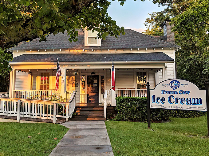 Home sweet ice cream home! This picture-perfect white farmhouse with its inviting porch practically whispers "slow down and treat yourself" to every passerby.