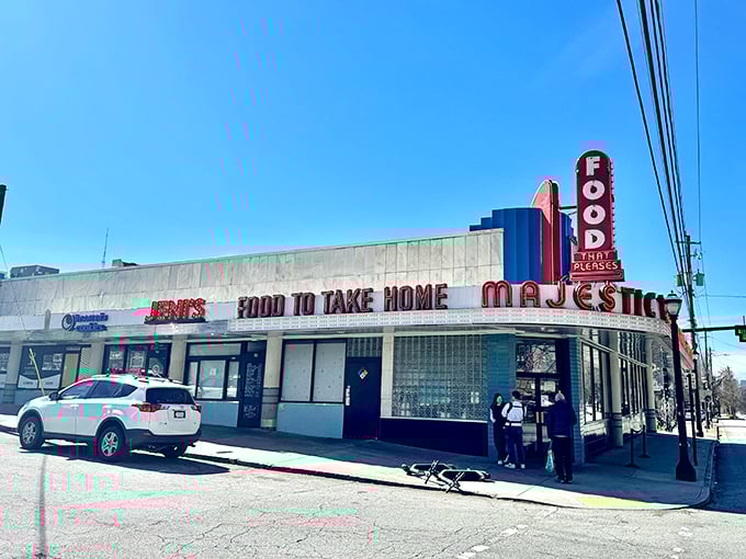 The iconic neon sign beckons like a lighthouse for hungry souls. Art Deco curves and that glorious "FOOD" proclamation&mdash;sometimes the simplest promises are the best ones.