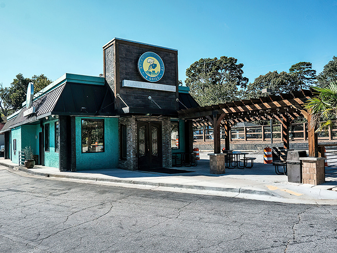 The teal-accented exterior with its wooden pergola isn't just inviting&mdash;it's a promise of seafood greatness waiting inside.