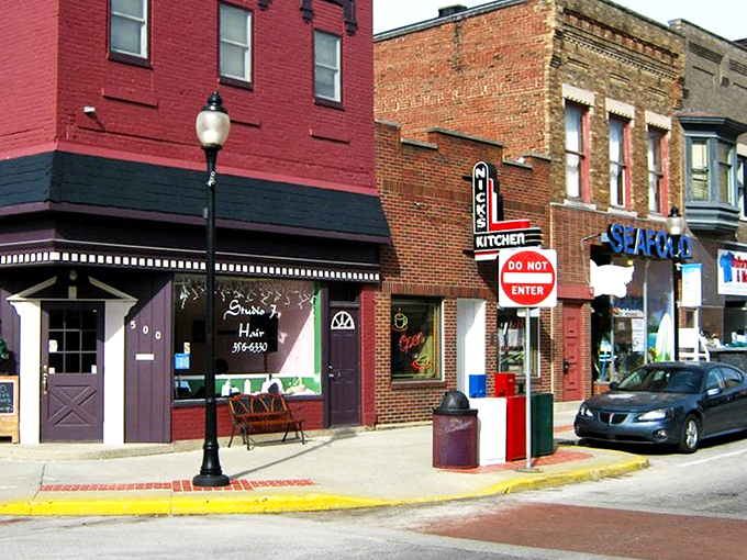 The iconic neon sign of Nick's Kitchen beckons like a lighthouse for hungry travelers in downtown Huntington. Comfort food paradise awaits!