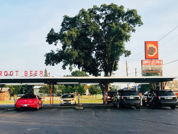 The classic neon "ROOT BEER" sign glows like a beacon to hungry travelers, promising nostalgic flavors under the Indiana sky.