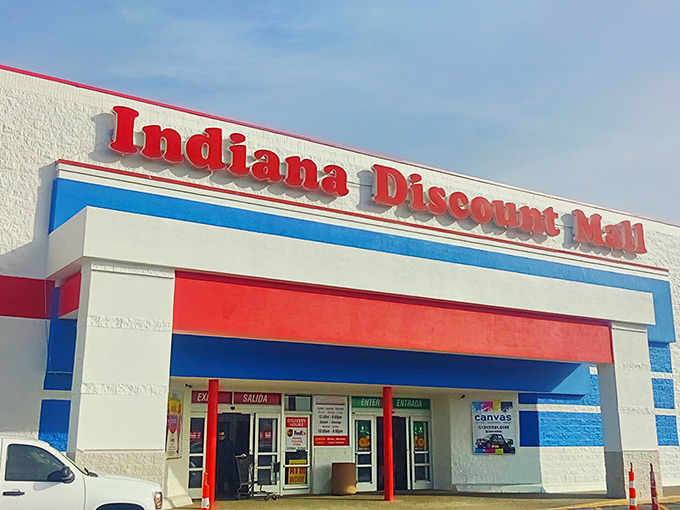 The red, white, and blue exterior serves as a retail lighthouse, guiding bargain hunters to shores where deals await and wallets breathe sighs of relief.