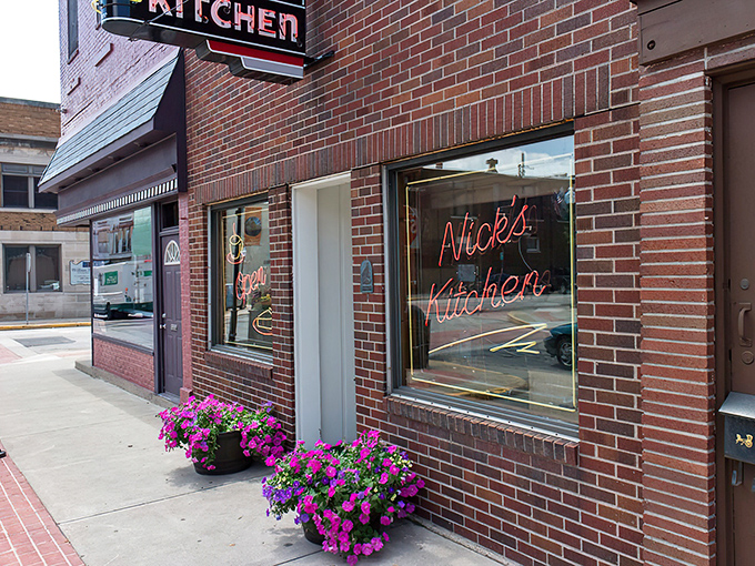 The iconic red brick corner building of Nick's Kitchen stands as a beacon of culinary history on Jefferson Street in downtown Huntington.