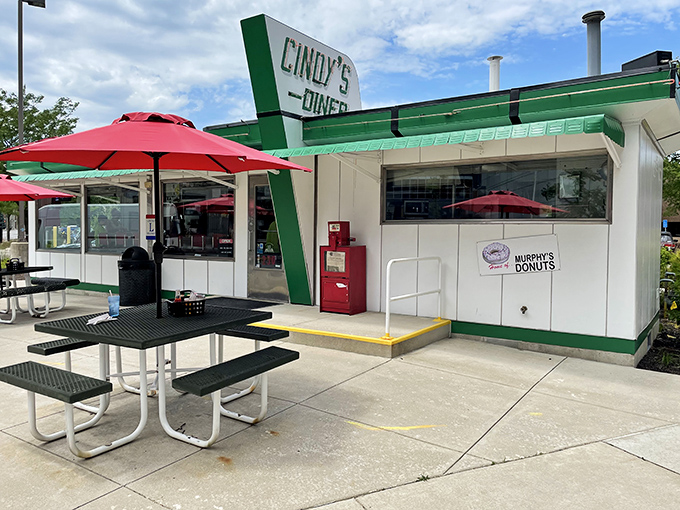 The classic green and white exterior of Cindy's Diner stands proudly in downtown Fort Wayne, promising breakfast magic with its vintage charm.