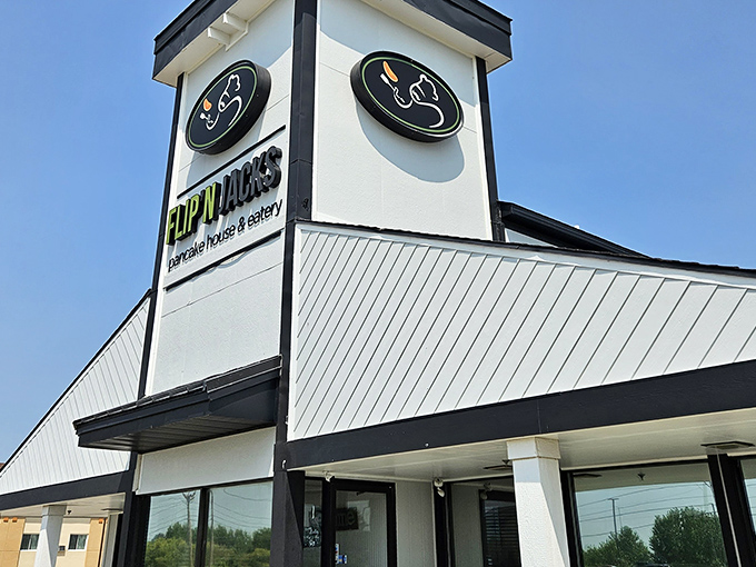 The distinctive peaked roof and farmhouse-style railing of Flip'N Jacks stands like a breakfast beacon in Ames, promising pancake paradise within.