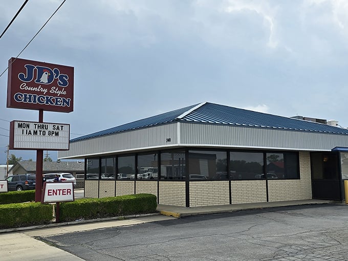 The unassuming blue-roofed building with its simple red sign might not scream "culinary destination," but locals know better. This modest exterior houses Kansas fried chicken royalty.