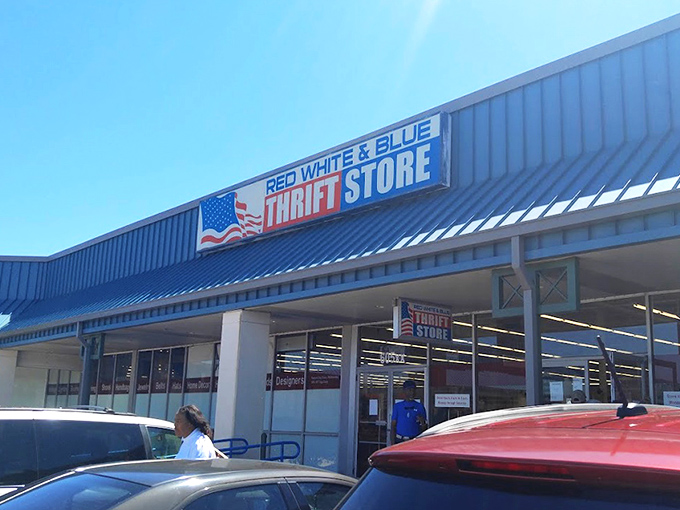 The patriotic facade of Red White & Blue Thrift Store stands like a treasure chest waiting to be opened, promising adventures in secondhand splendor under the Louisiana sun.  