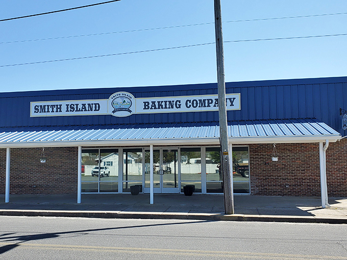 The blue-fronted bakery stands like a beacon of sweetness in Crisfield, promising layer upon layer of Maryland tradition behind those glass doors.