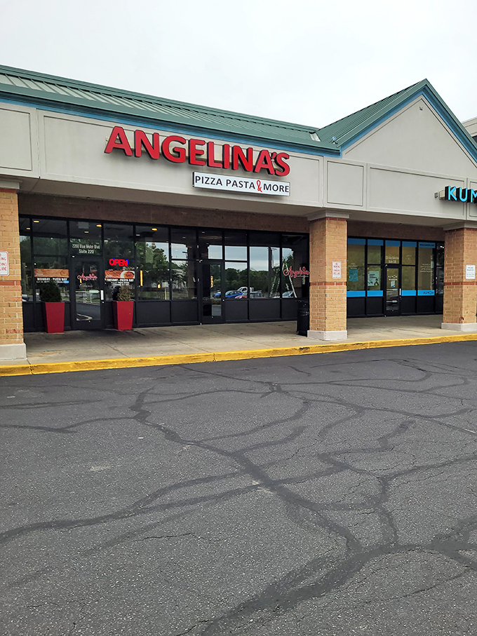 The bright red signage beckons like a lighthouse for the pasta-starved. Come for the promise of "Pizza Pasta & More," stay for the red umbrella charm.