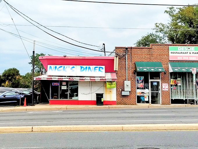 A beacon of breakfast bliss! Nick's Diner's vibrant red exterior is like a siren call to hungry souls, promising comfort food and nostalgia in equal measure.