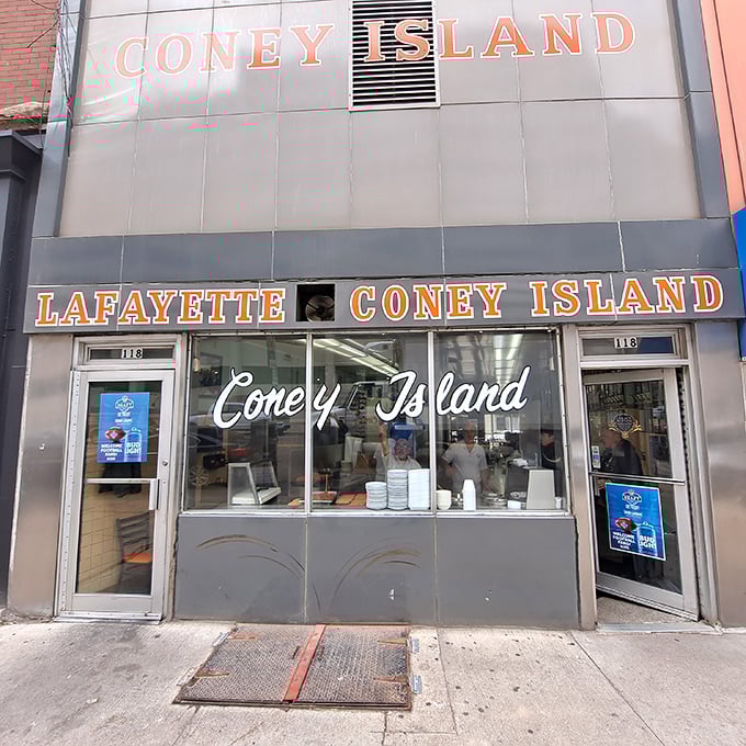 The iconic Lafayette Coney Island fa&ccedil;ade glows like a beacon for hungry night owls, promising Detroit's most famous comfort food against the city skyline.