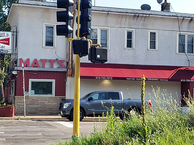 The unassuming exterior of Matt's Bar stands like a humble temple to burger perfection, its red and white facade hiding culinary treasures within.