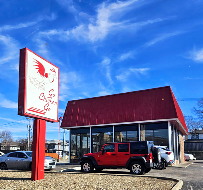 The iconic red-roofed building with its distinctive running chicken sign stands as a beacon of fried chicken perfection in Kansas City. 