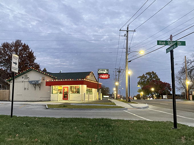 The iconic Carl's Drive-In sign stands like a beacon of burger paradise against the Missouri sky. Some landmarks never need updating.