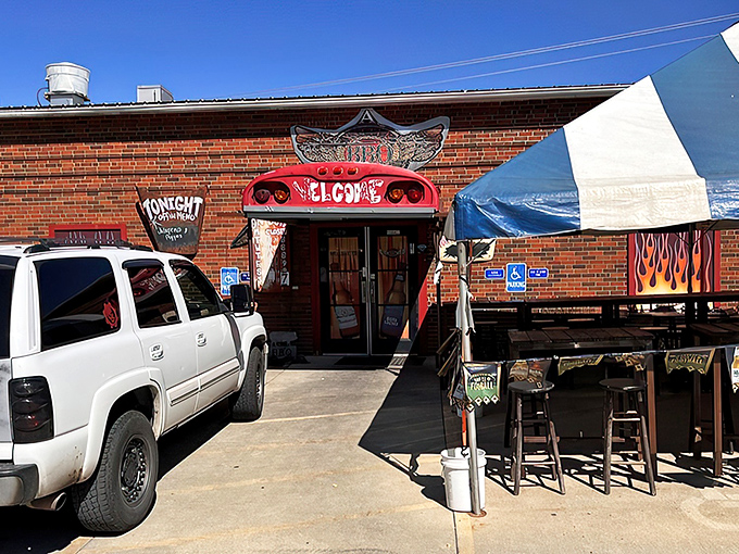 The unassuming brick exterior promises barbecue greatness with its cheeky welcome sign and flame-adorned entryway. Meat paradise awaits.