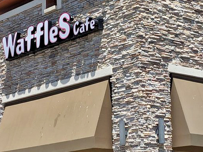 The stone facade of Waffles Cafe stands like a humble temple to breakfast, promising griddle-based salvation away from the neon chaos of the Strip.