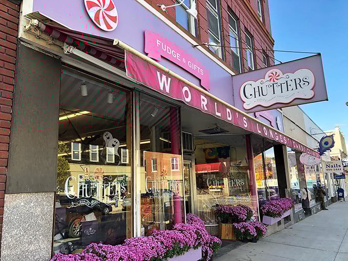The iconic pink storefront of Chutters beckons like a sugary mirage on Littleton's Main Street. Those purple flowers aren't just decoration&mdash;they're a warning sign that willpower goes to die here.