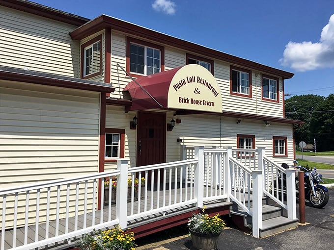 The unassuming exterior of Pasta Loft belies the culinary treasures within. That bicycle on the roof? It's how the staff burns off all those carbs.