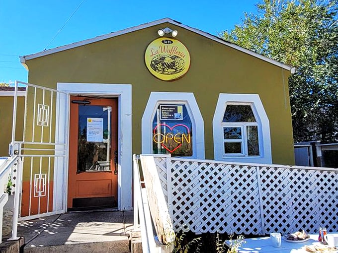 The cheerful mustard-yellow exterior of Tia B's La Waffleria stands like a beacon of breakfast hope in Albuquerque's landscape.